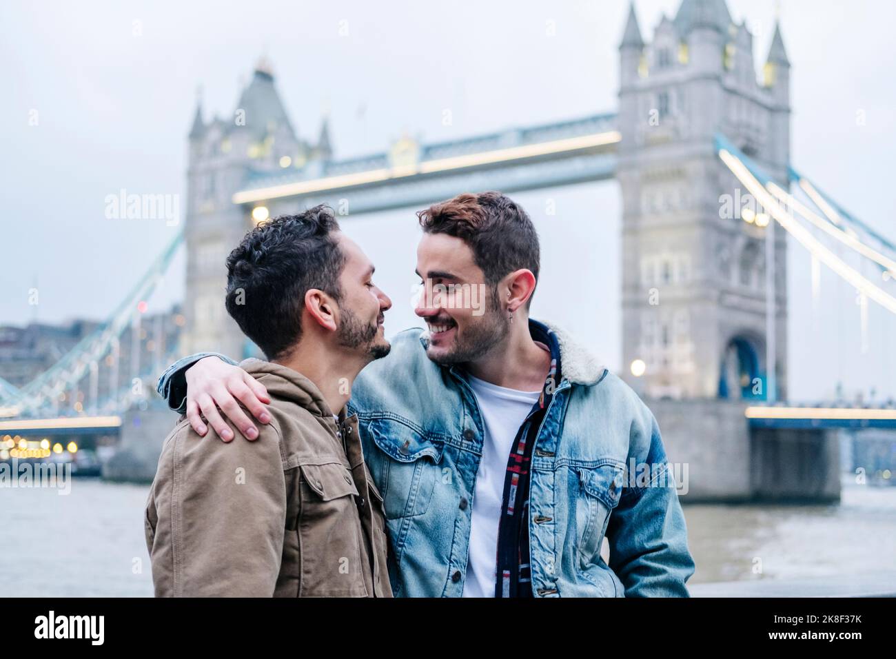 London, United Kingdom, A couple of guys embracing in front of Tower ...