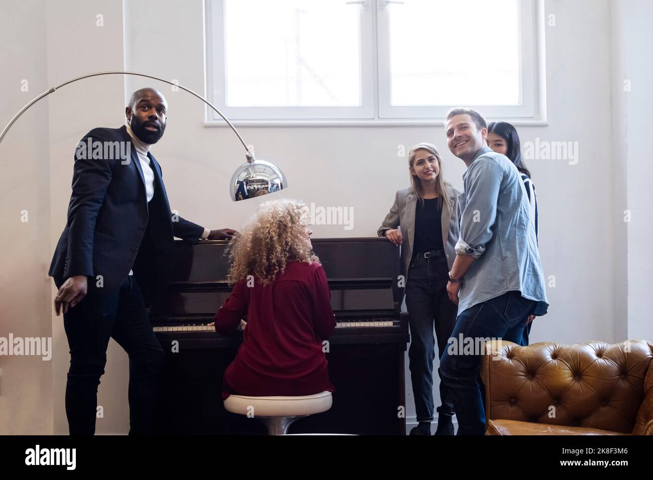 Happy business colleagues playing music at office Stock Photo - Alamy