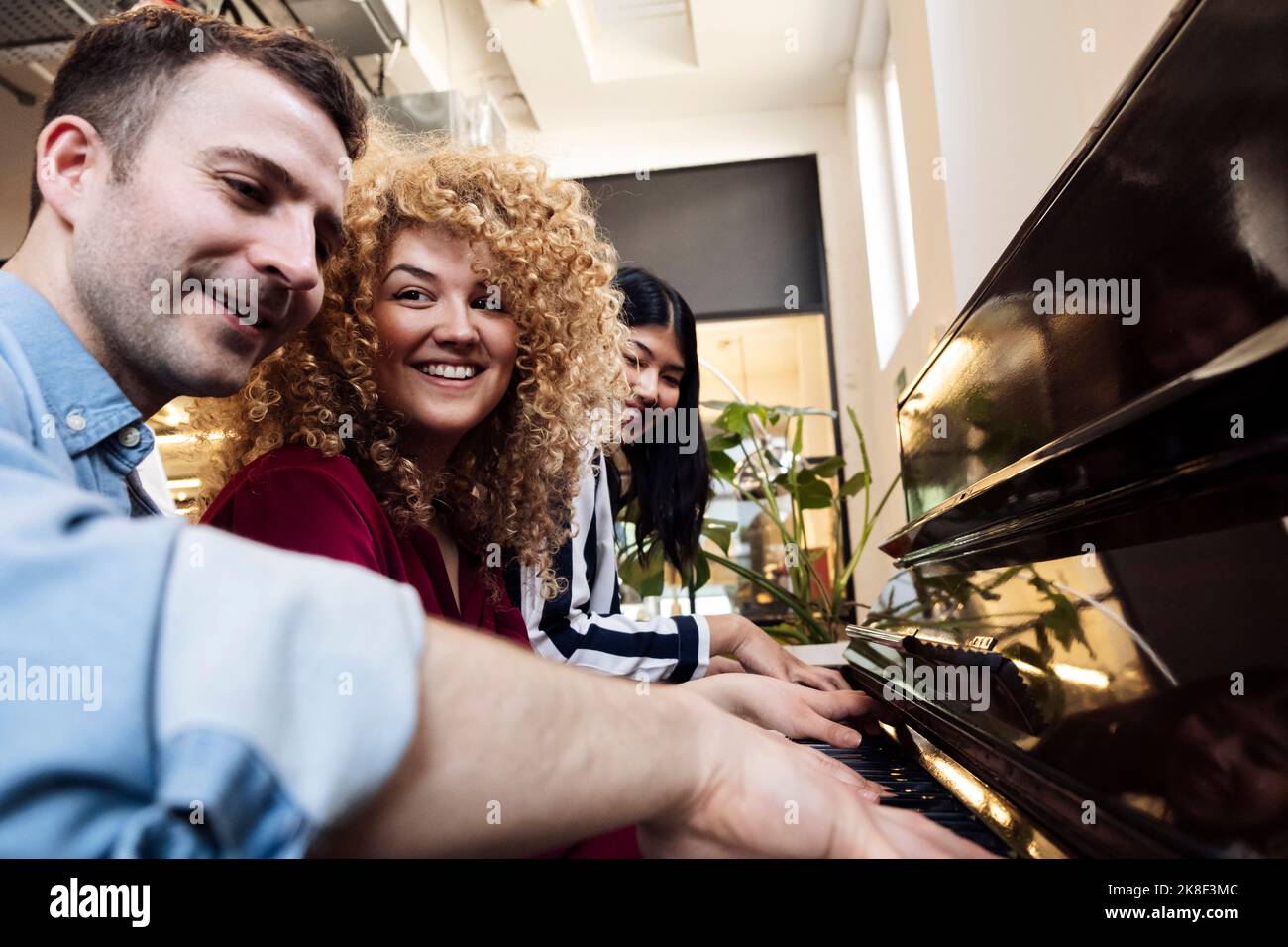 Happy business colleagues playing music at office Stock Photo - Alamy