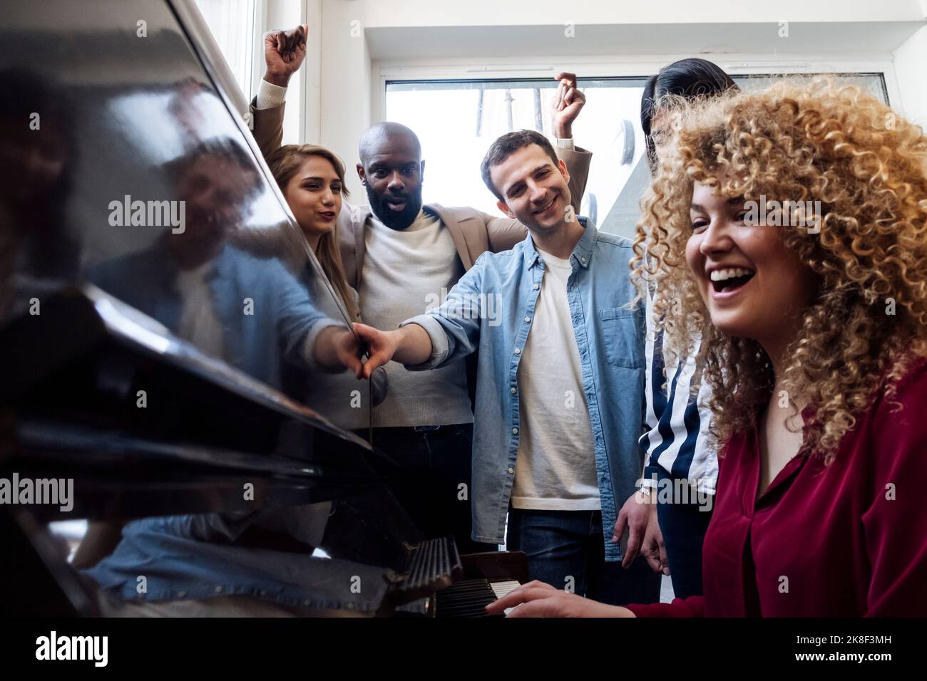 Happy business colleagues playing music at office Stock Photo - Alamy