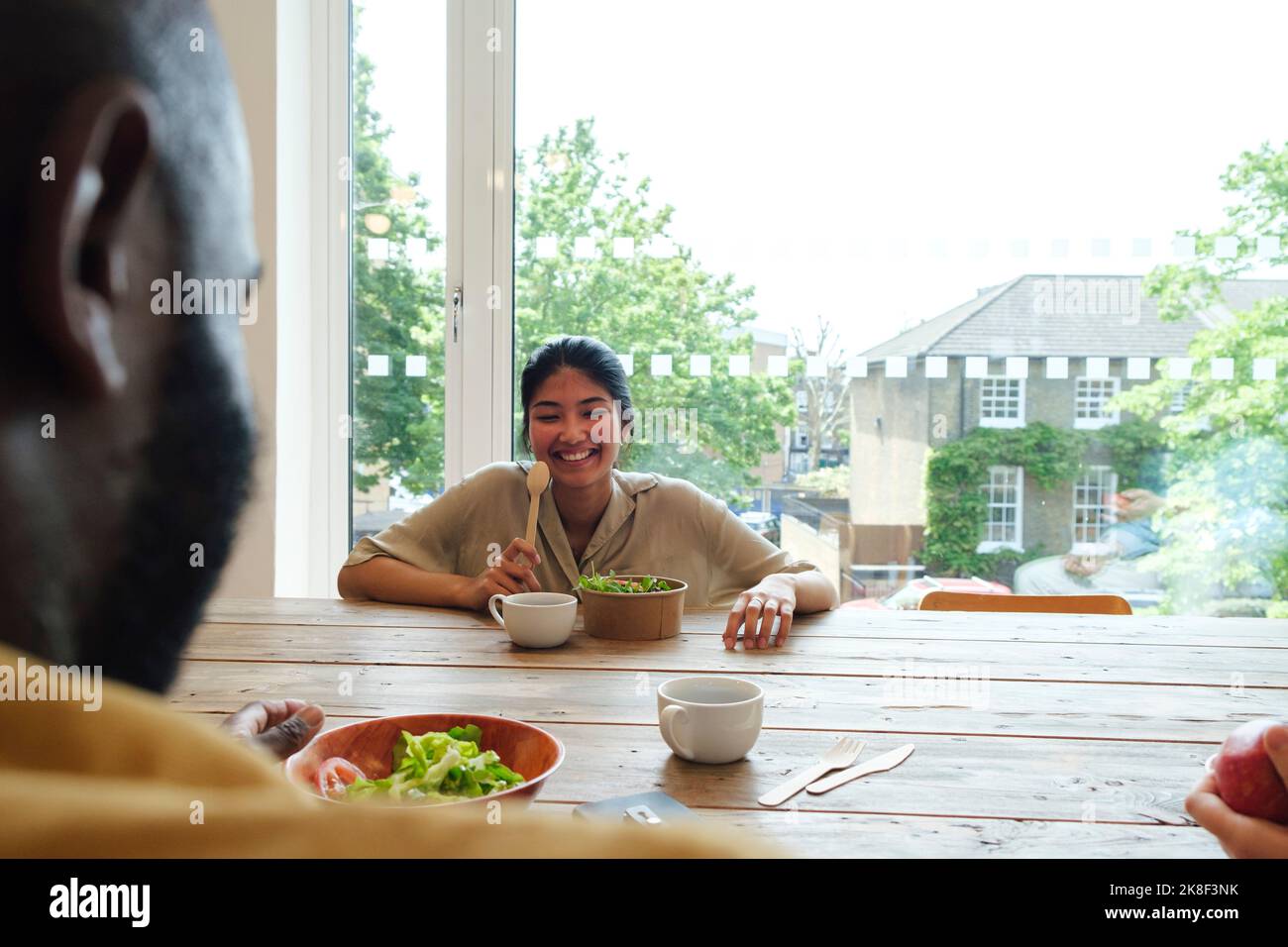 Business people having healthy lunch together in staff room at modern ...