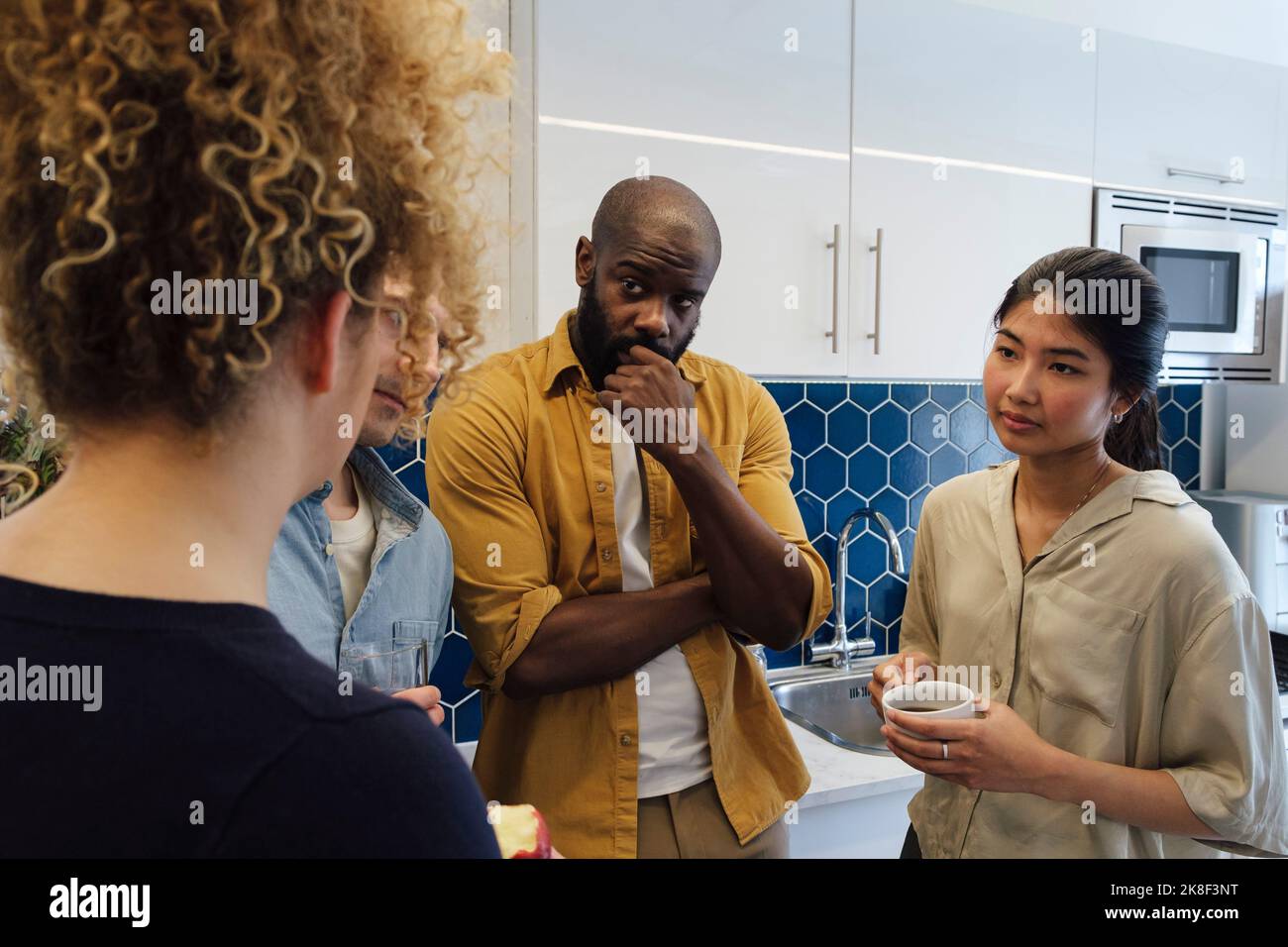 Business people talking in office kitchen at tea break Stock Photo - Alamy