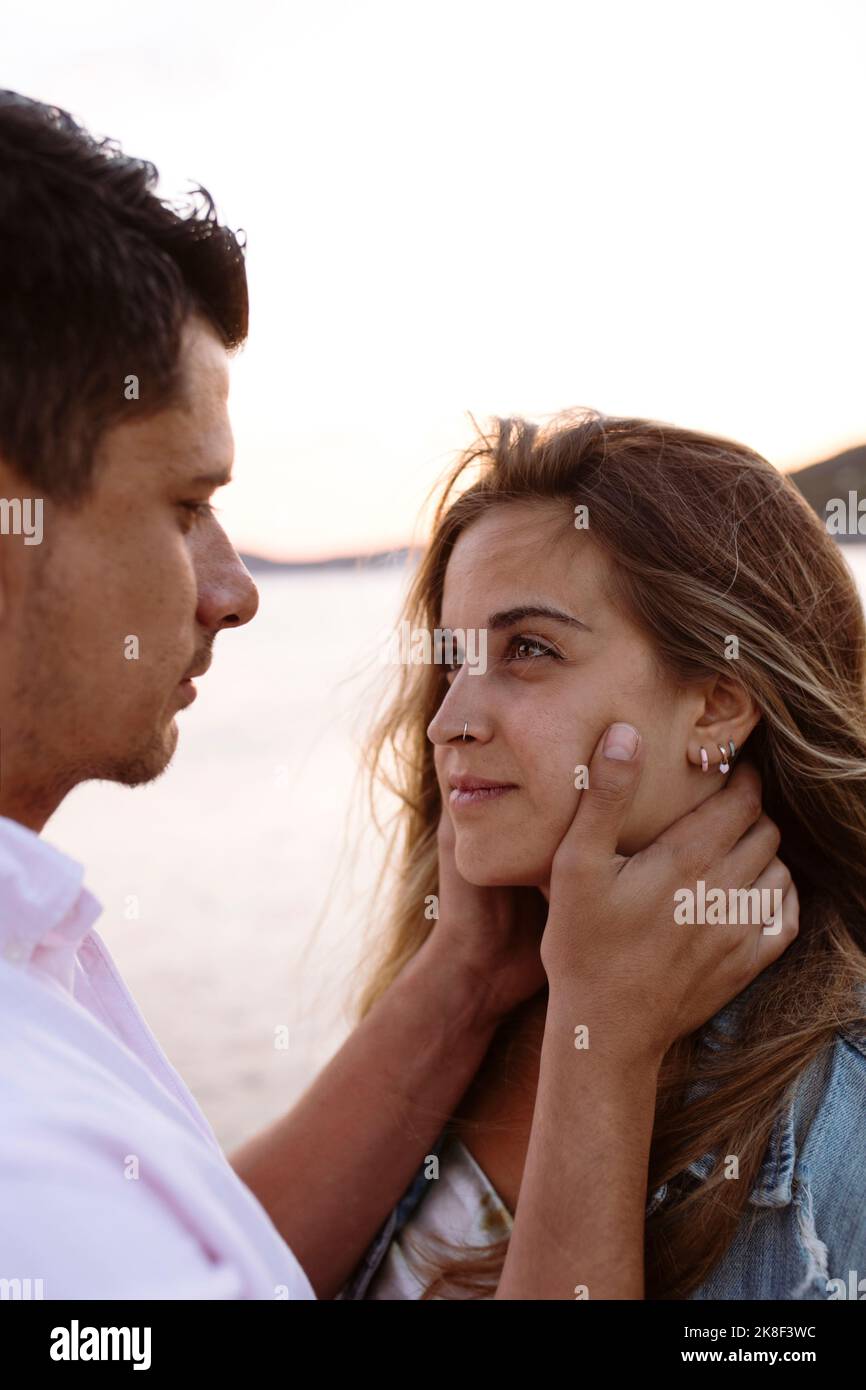 Romantic young couple looking at each other Stock Photo - Alamy