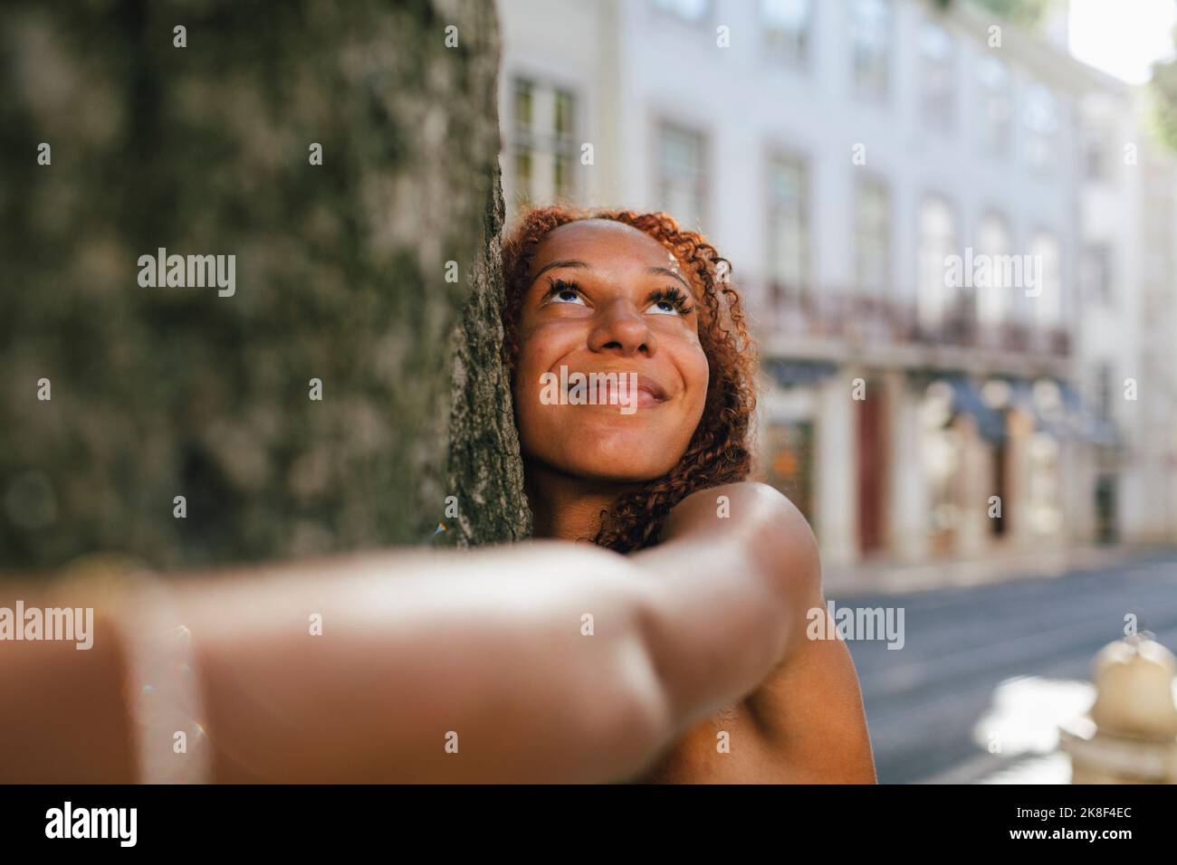 Young woman hugging tree trunk hi-res stock photography and images - Alamy