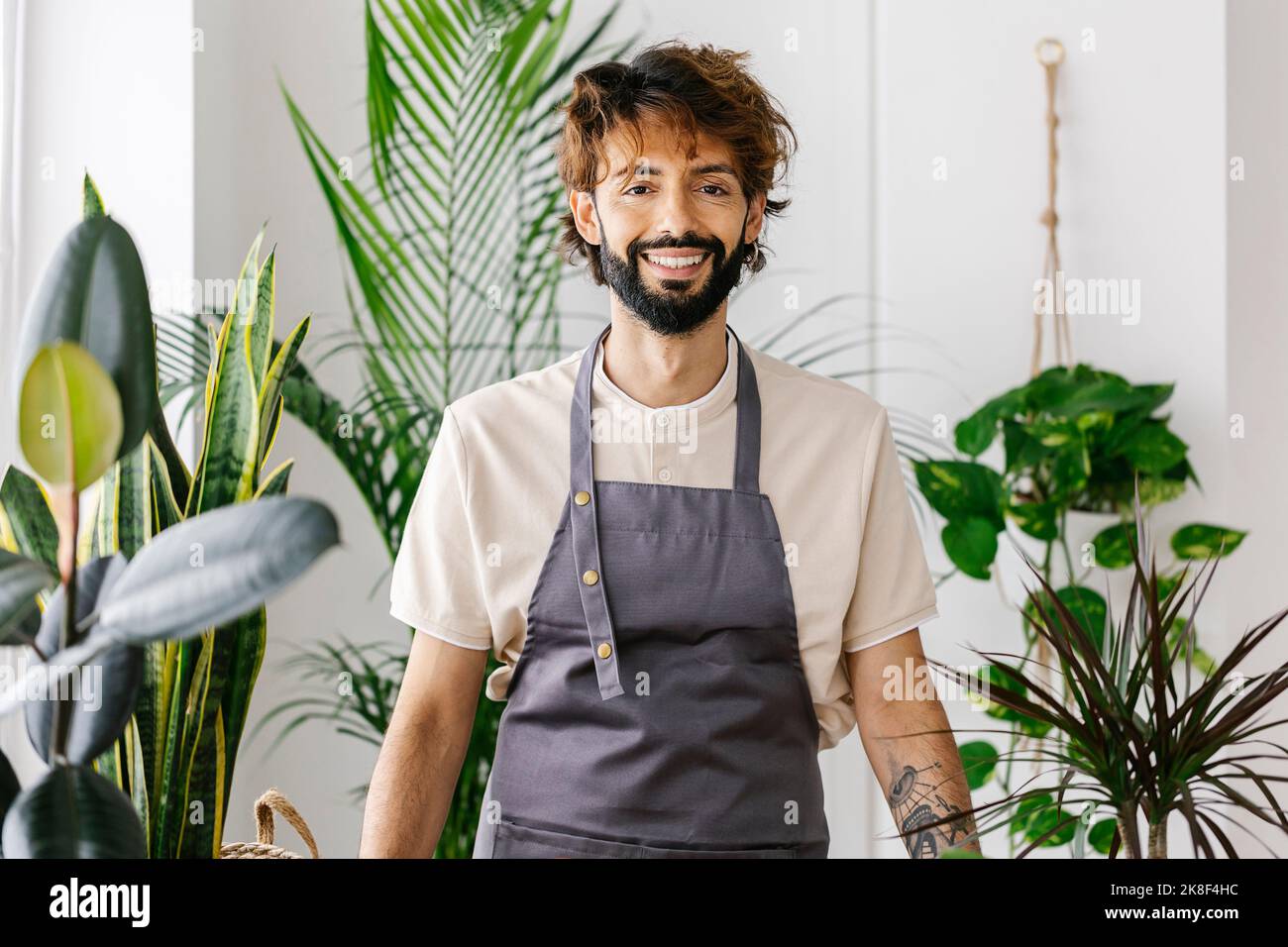 Smiling owner of plant shop Stock Photo - Alamy