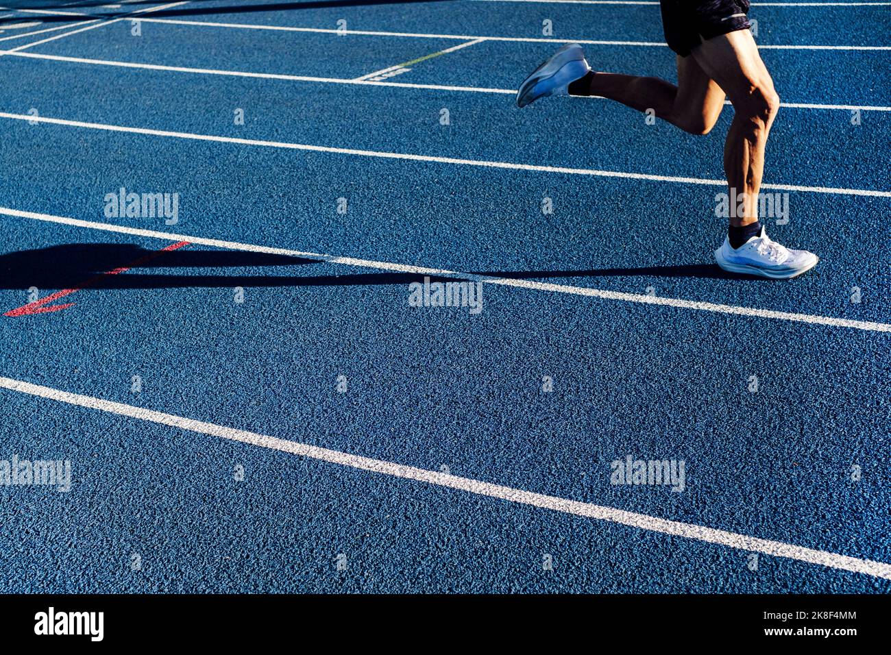 Mature athlete running on track Stock Photo - Alamy