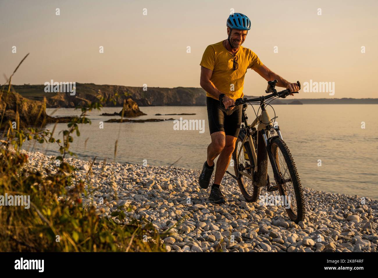 Man walking bicycle hi-res stock photography and images - Alamy