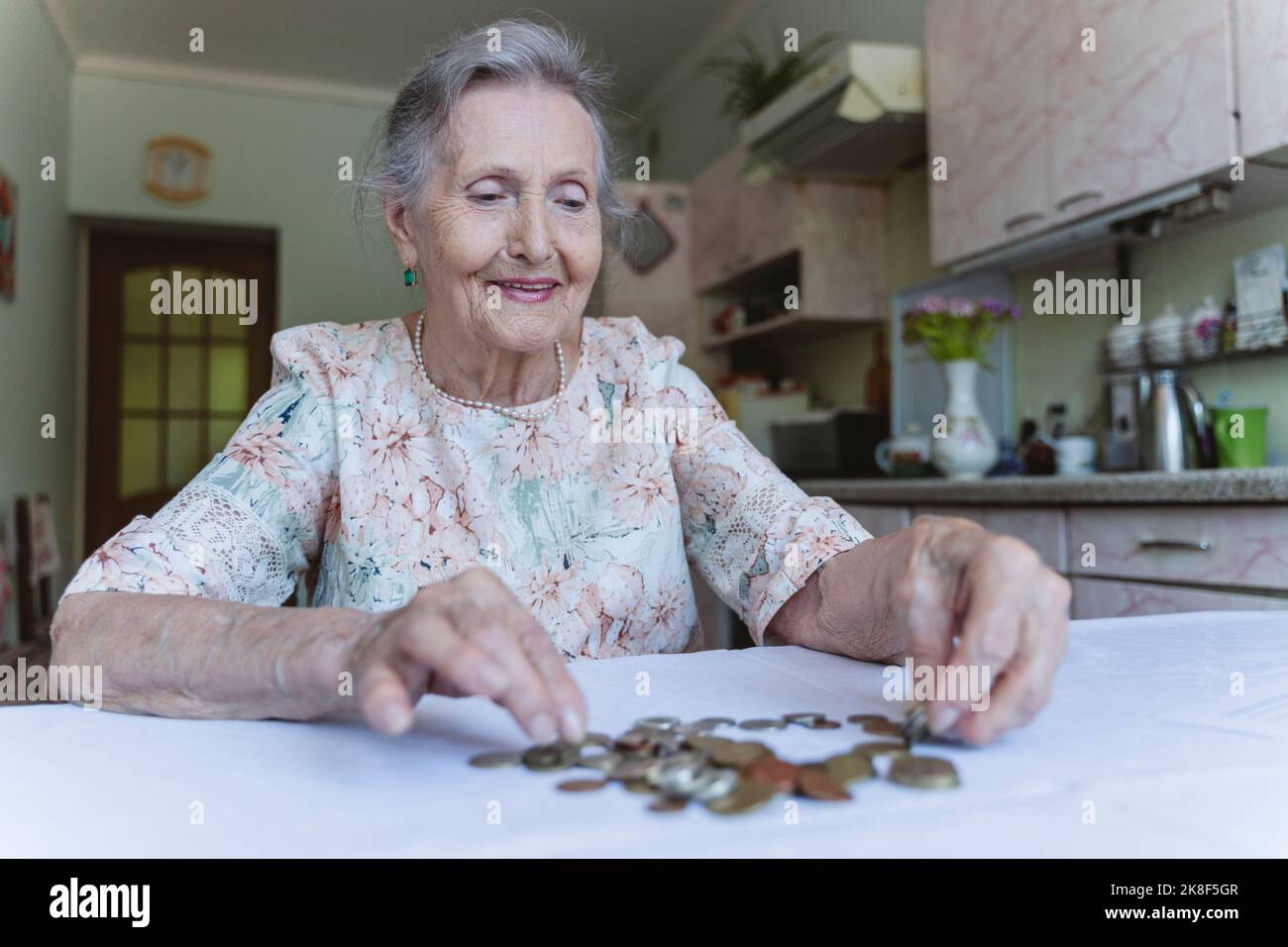 Senior woman counting coins hi-res stock photography and images - Alamy