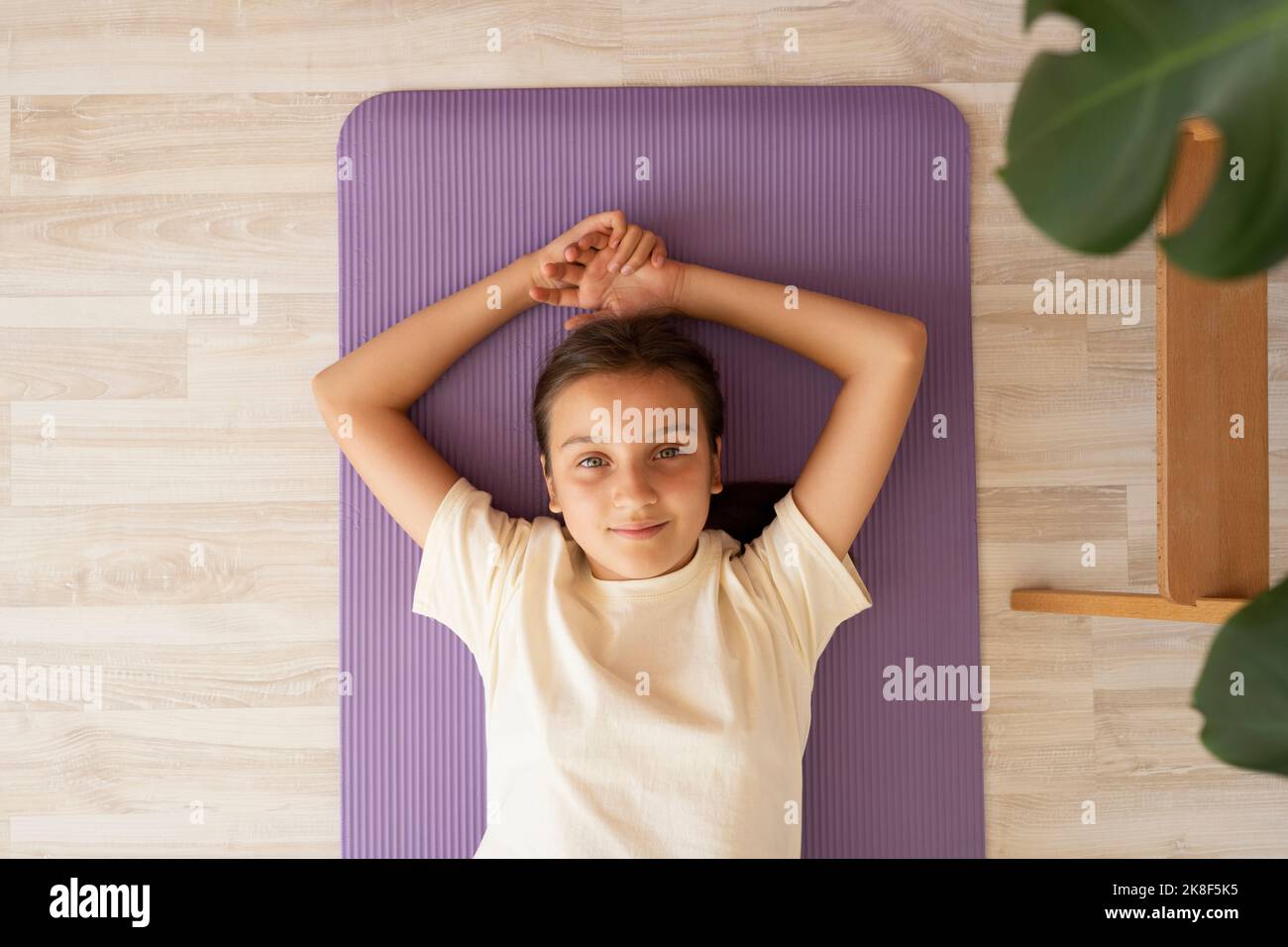 Girl lying on exercise mat hi-res stock photography and images - Alamy