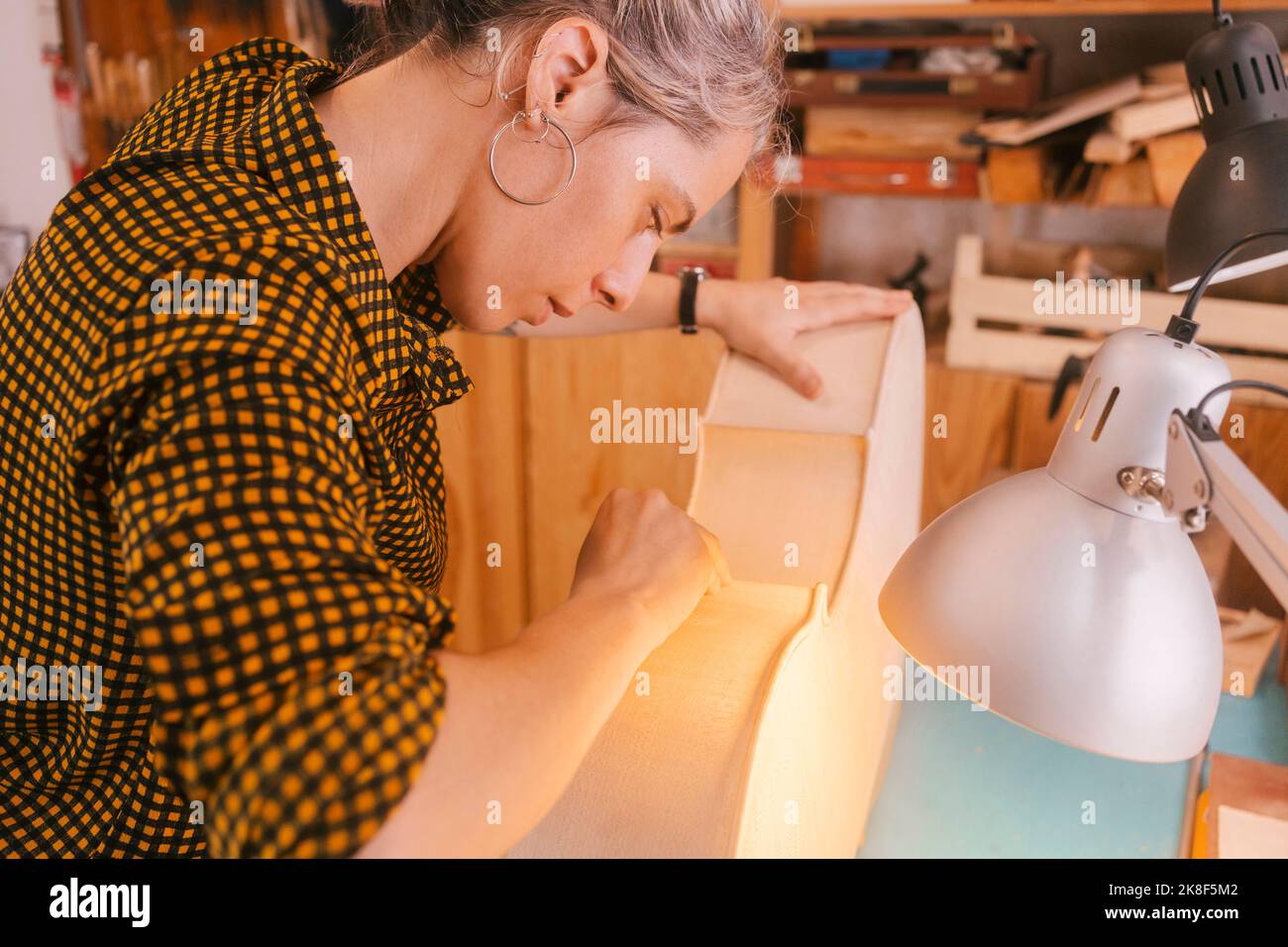 Luthier making double bass musical instrument at workshop Stock Photo ...