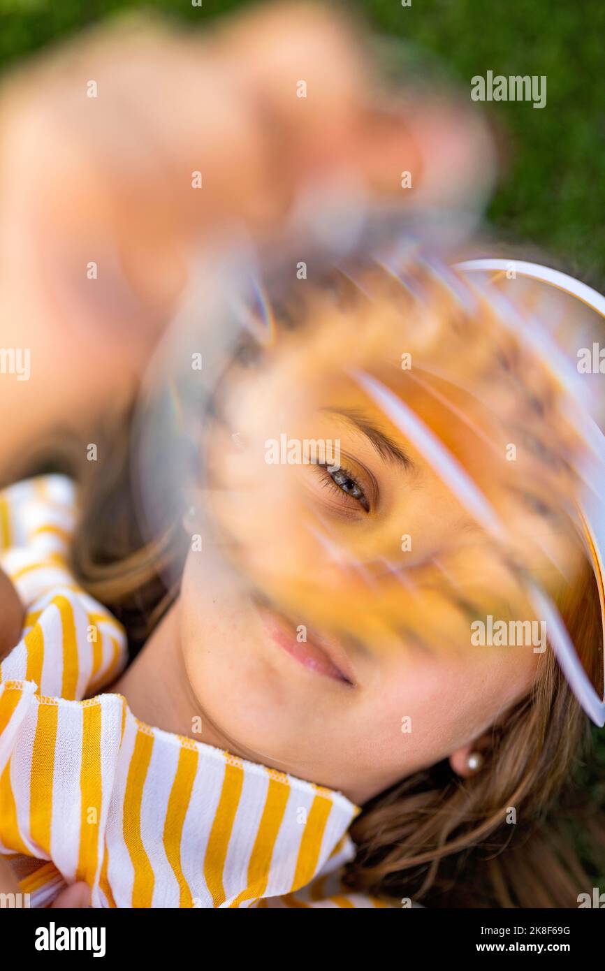 Girl wearing sun visor looking through object Stock Photo - Alamy