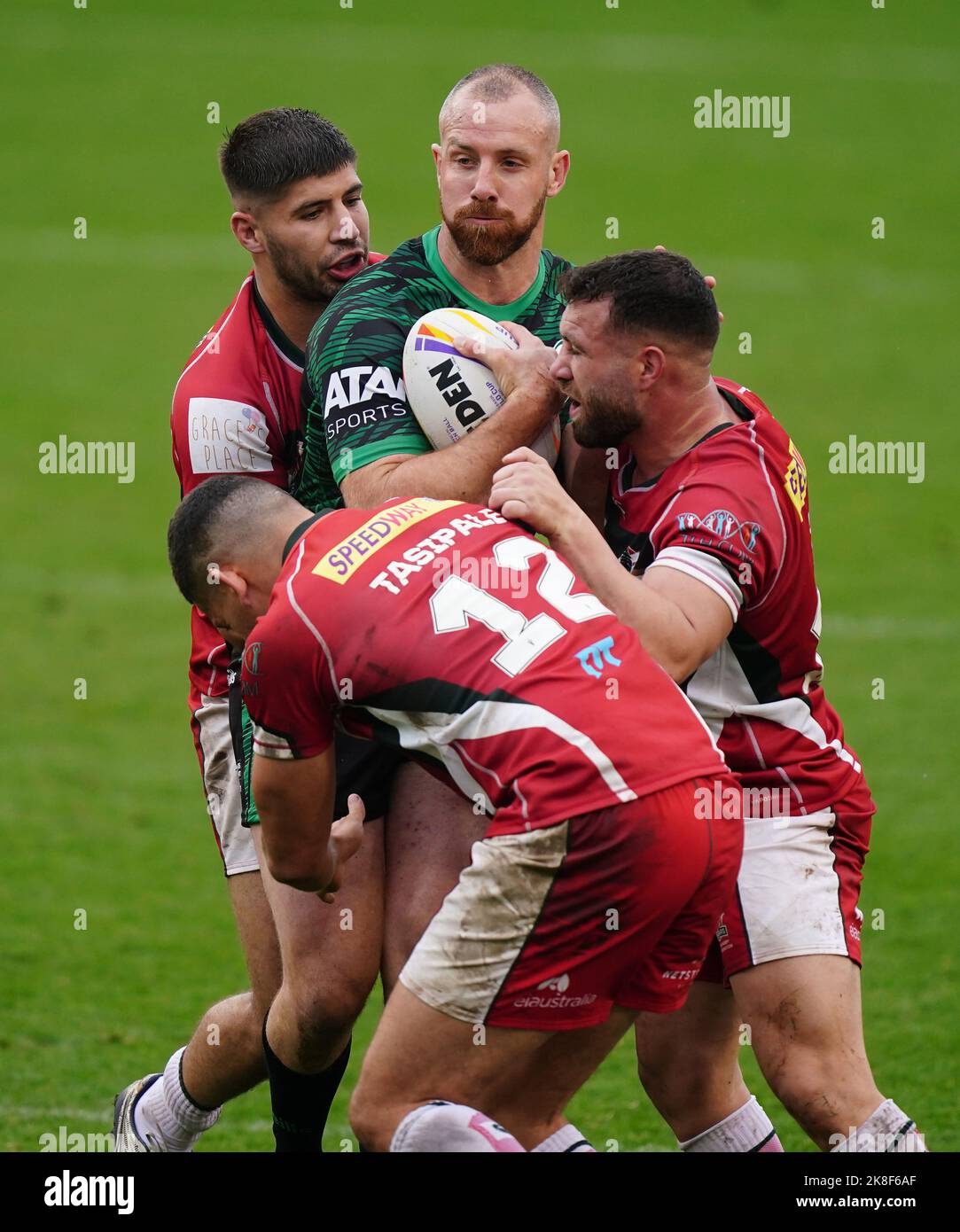 Ireland's James Hasson (centre) is tackled by Lebanon's James Roumanos ...