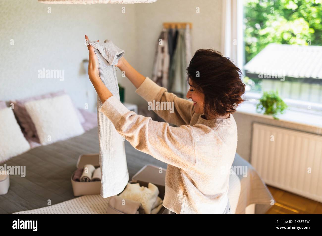 Woman female folding clothing clothes hi-res stock photography and ...