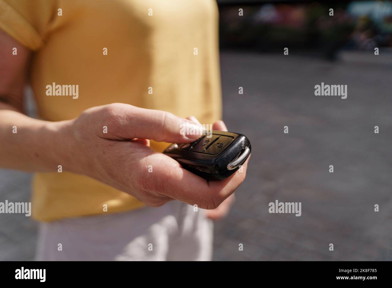 Hand of mature woman holding car key Stock Photo - Alamy