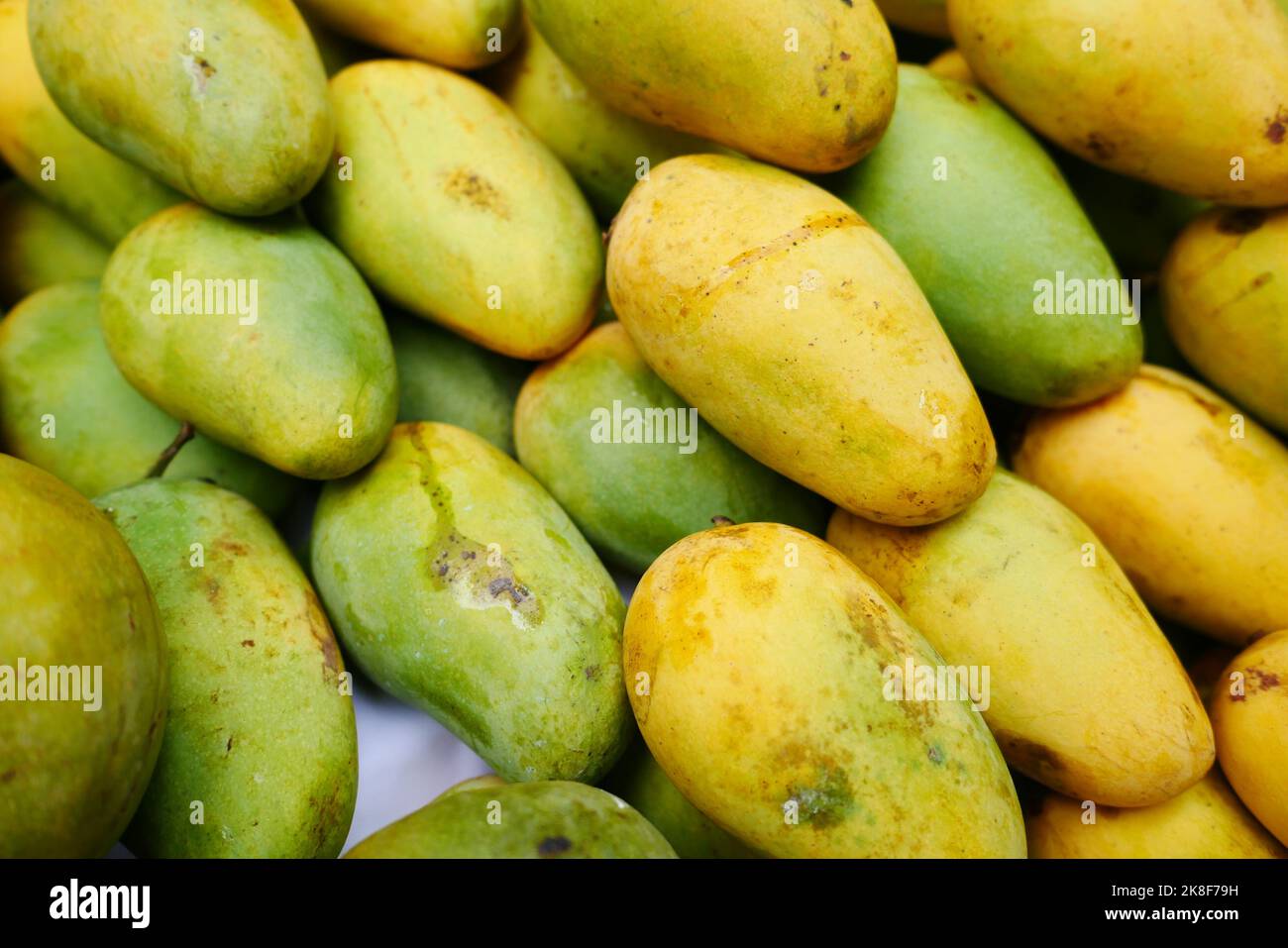 Fresh green mango on black background top down Stock Photo - Alamy