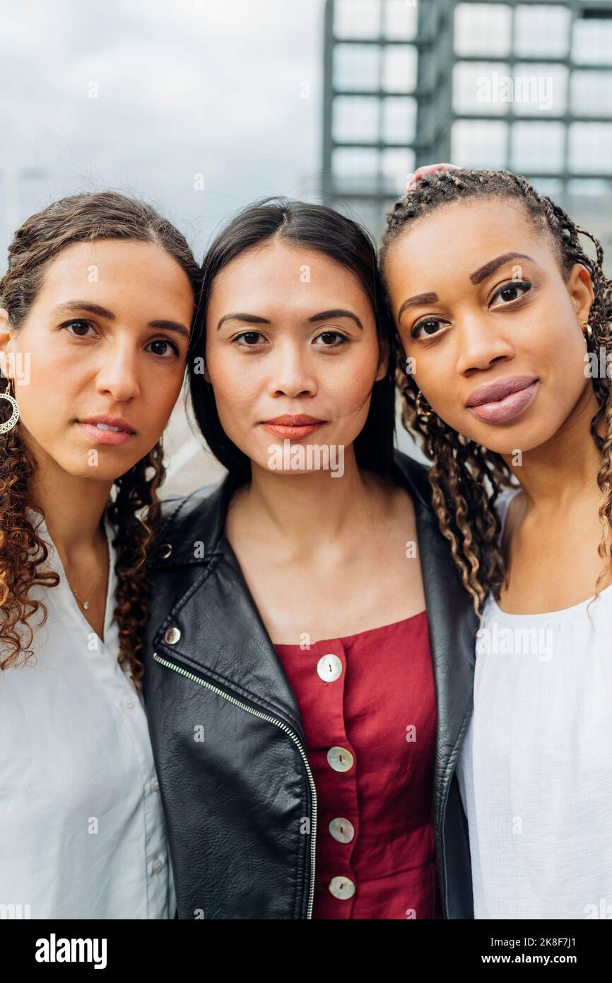 Young multiracial friends standing side by side Stock Photo - Alamy