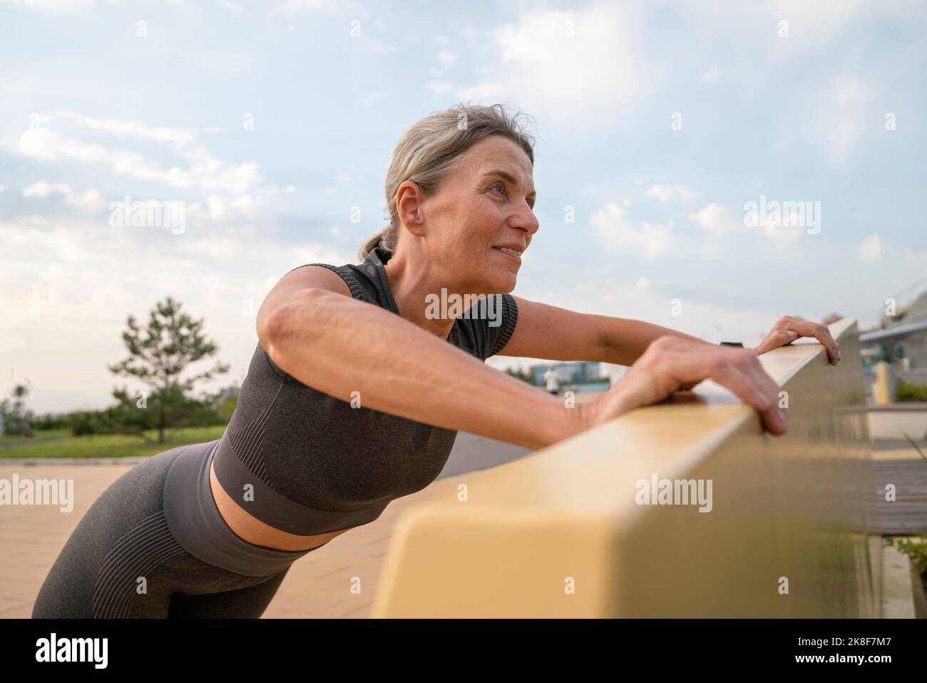 Mature woman doing push-ups on bench Stock Photo - Alamy