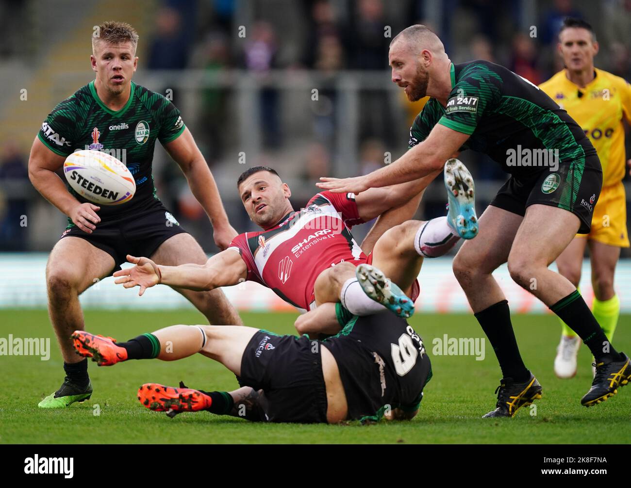 Lebanon's Josh Mansour (centre) is tackled by Ireland's James Hasson ...