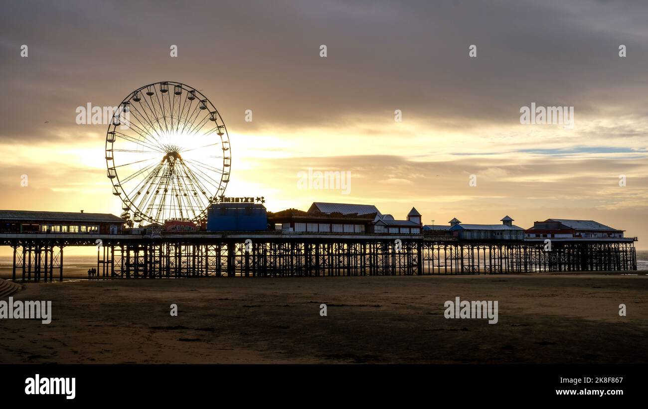 Blackpool Pier with its Ferris wheel and the sunset behind streaming ...