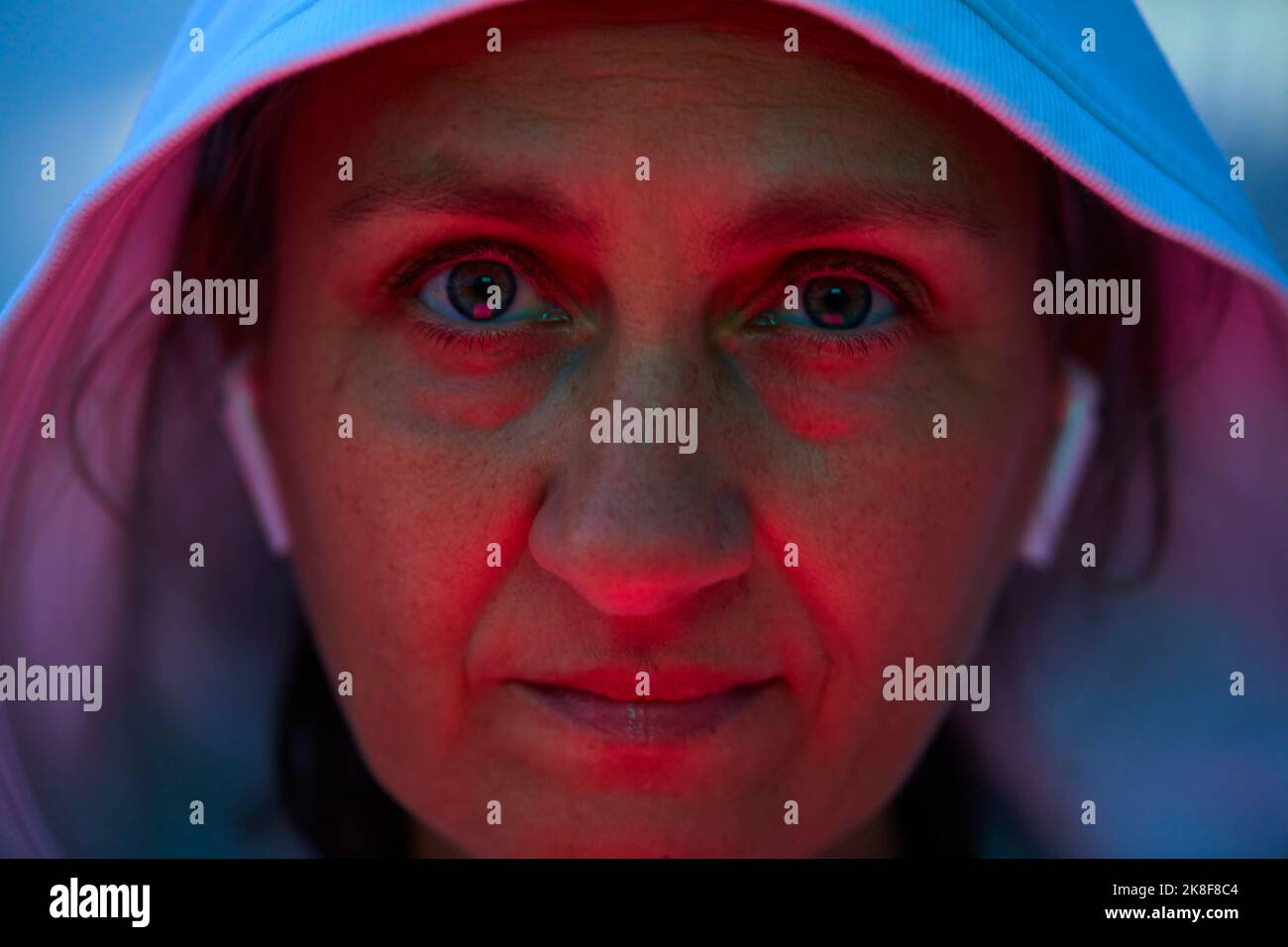 Face of woman with reflection of red light Stock Photo - Alamy