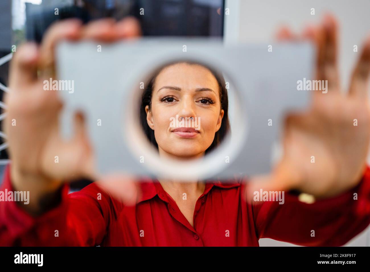 Engineer holding and examining machine part at factory Stock Photo - Alamy