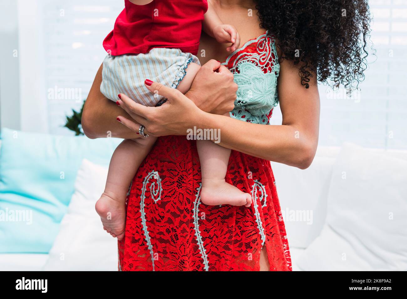 Mother carrying baby boy at home Stock Photo - Alamy