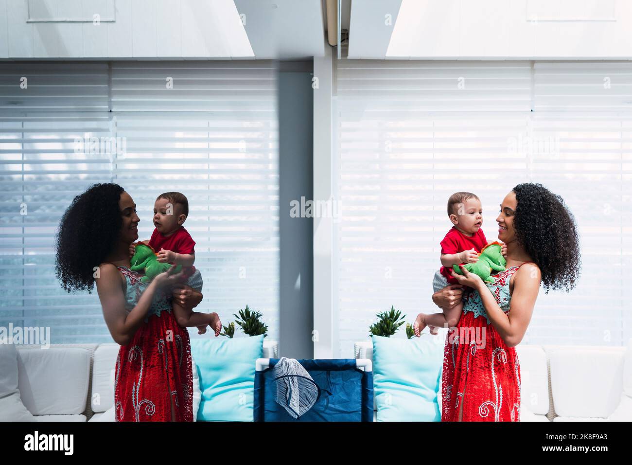 Happy woman with baby boy standing in front of mirror at home Stock ...