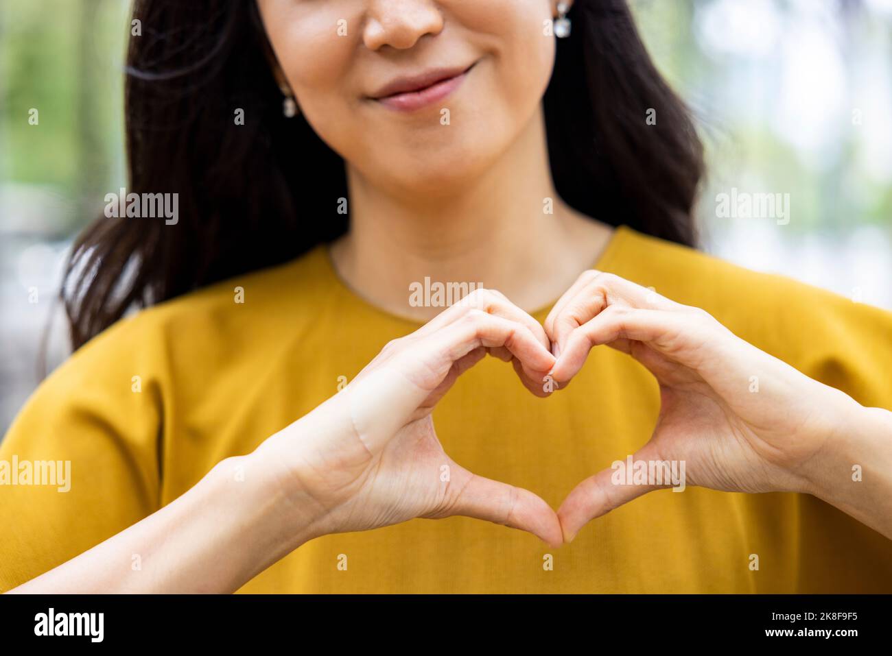 Asian hands on heart hi-res stock photography and images - Alamy
