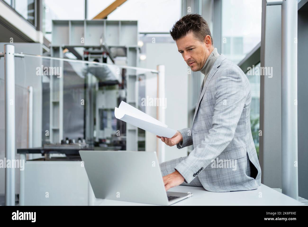 Mature businessman working paper hi-res stock photography and images ...