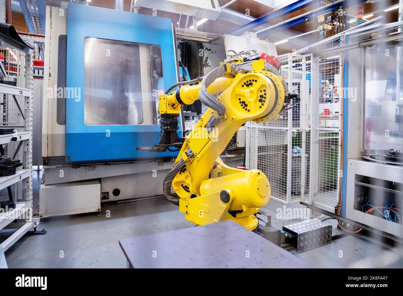 Robotic arm in front of machine Stock Photo - Alamy