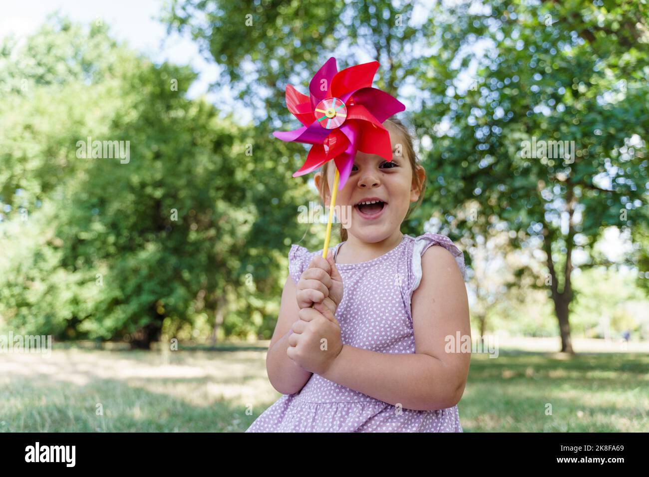 Happy girl holding toy hi-res stock photography and images - Alamy