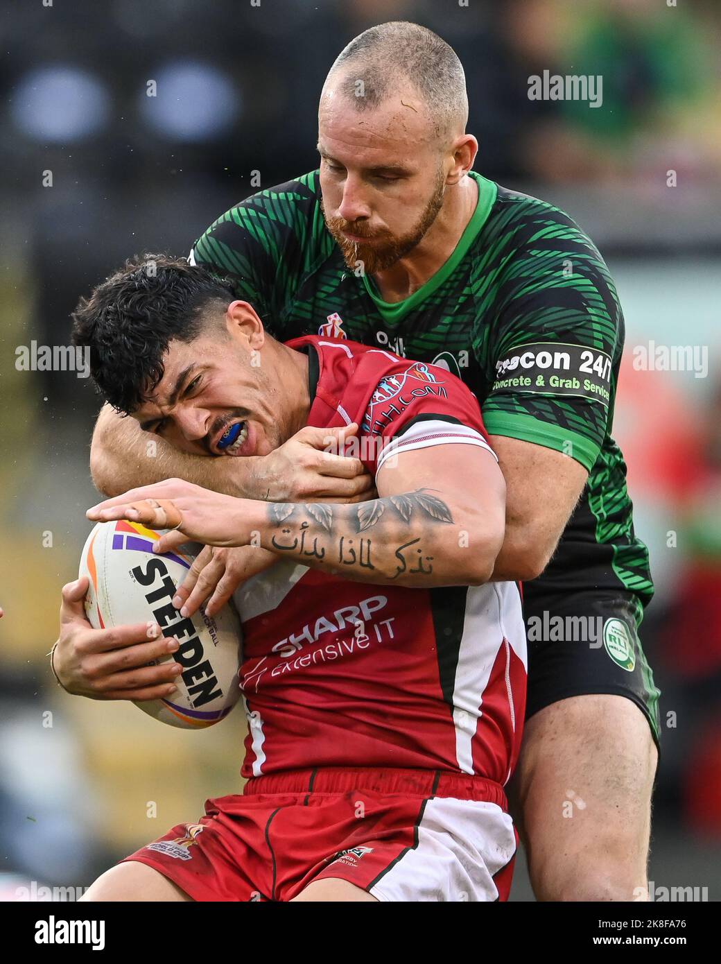 Brandon Morkos of Lebanon is tackled by James Hasson of Ireland during ...