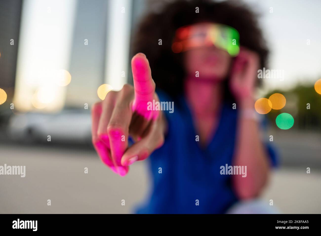 Pink light falling on woman's finger Stock Photo - Alamy
