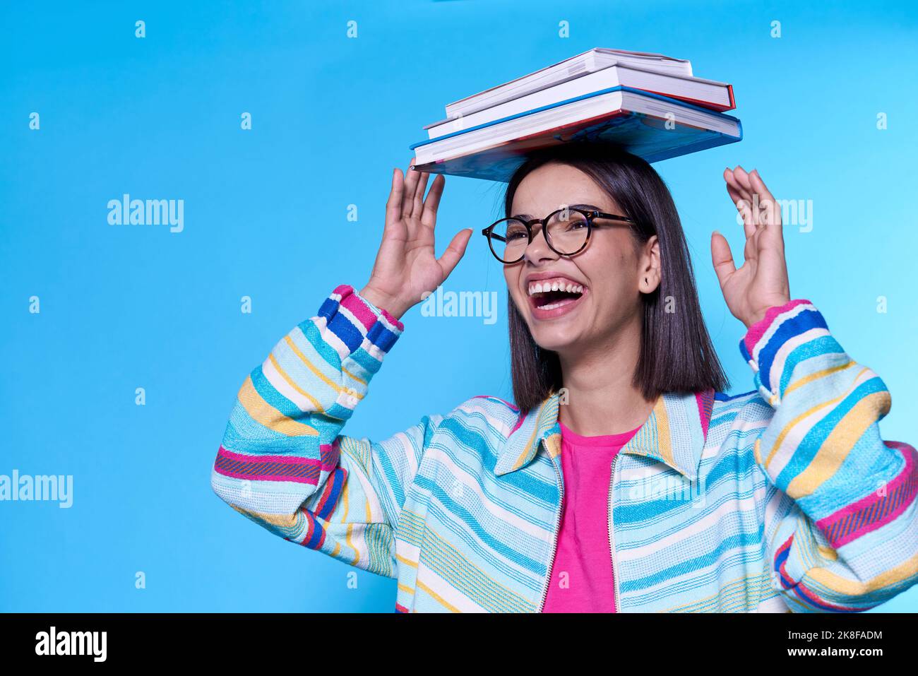 Woman balancing books head hi-res stock photography and images - Alamy