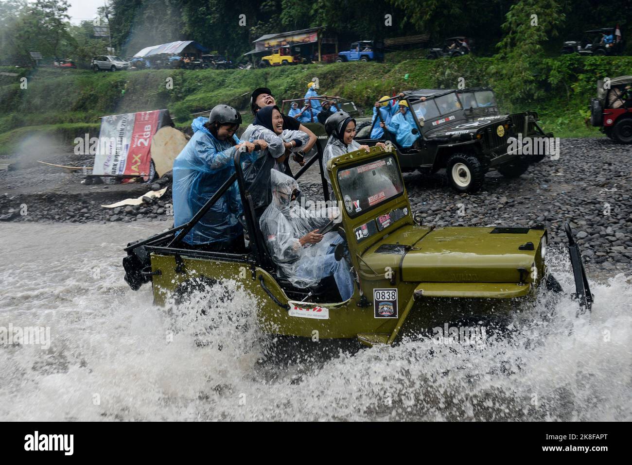 Local tourists ride off-road jeep at Kali Kuning river in the slope of ...