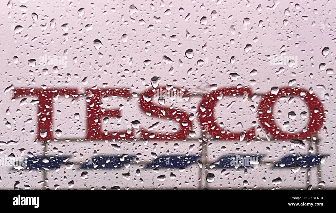 Tesco sign pictured through a car window covered in raindrops. Bicester ...