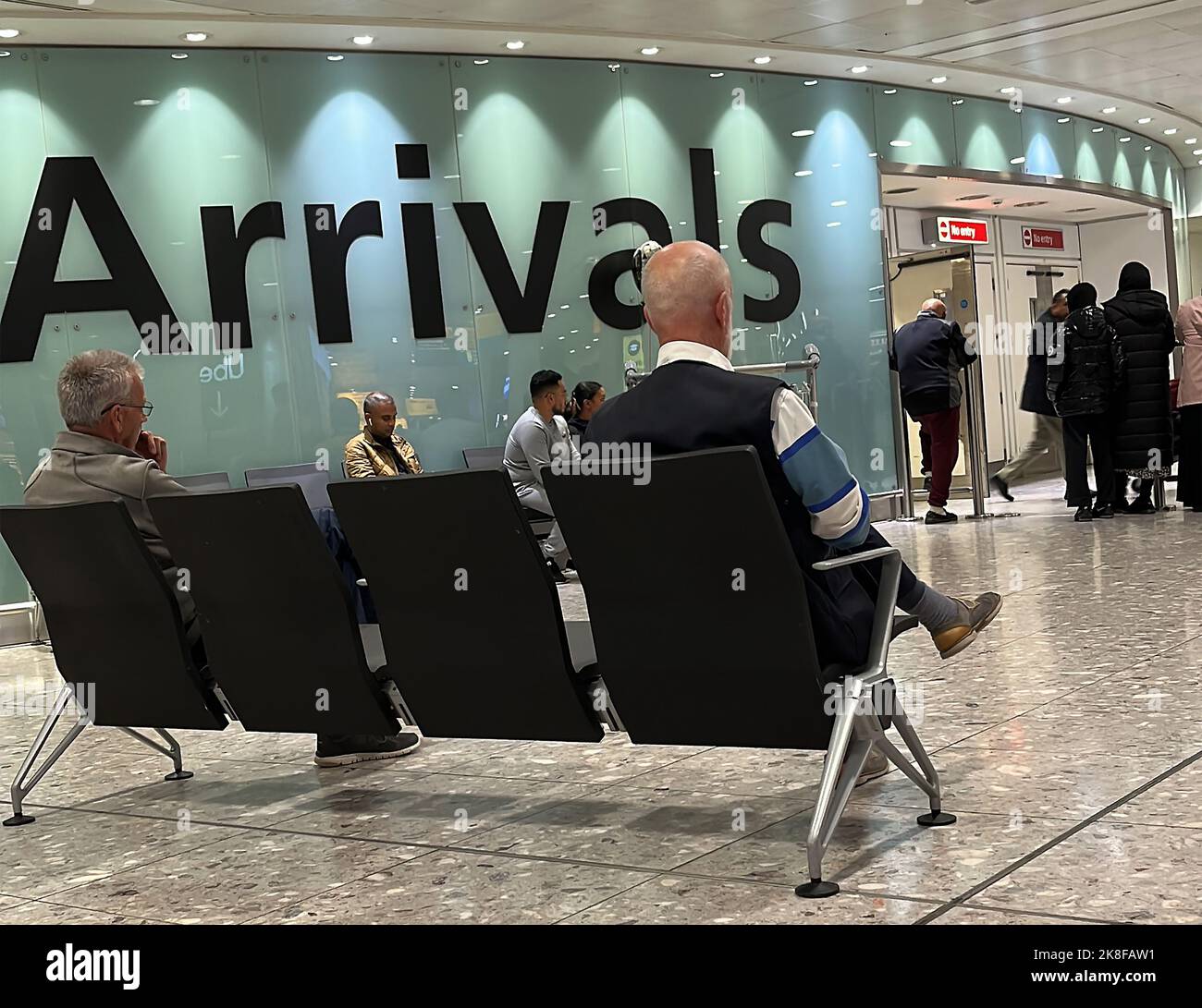 People wait at arrivals at London Heathrow Airport terminal 3. UK ...