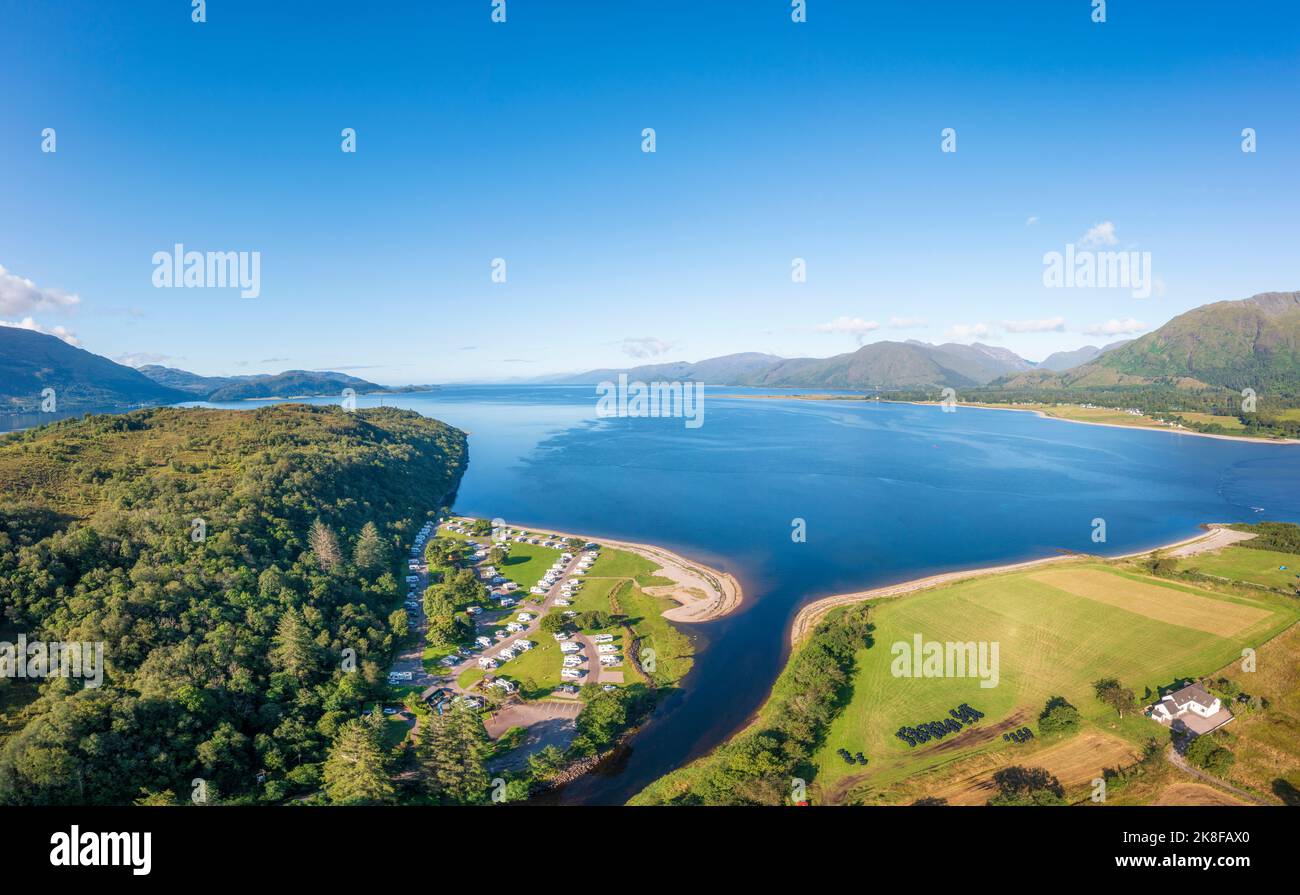 Aerial view of Loch Linnhe and camper van site under blue sky, Scotland ...