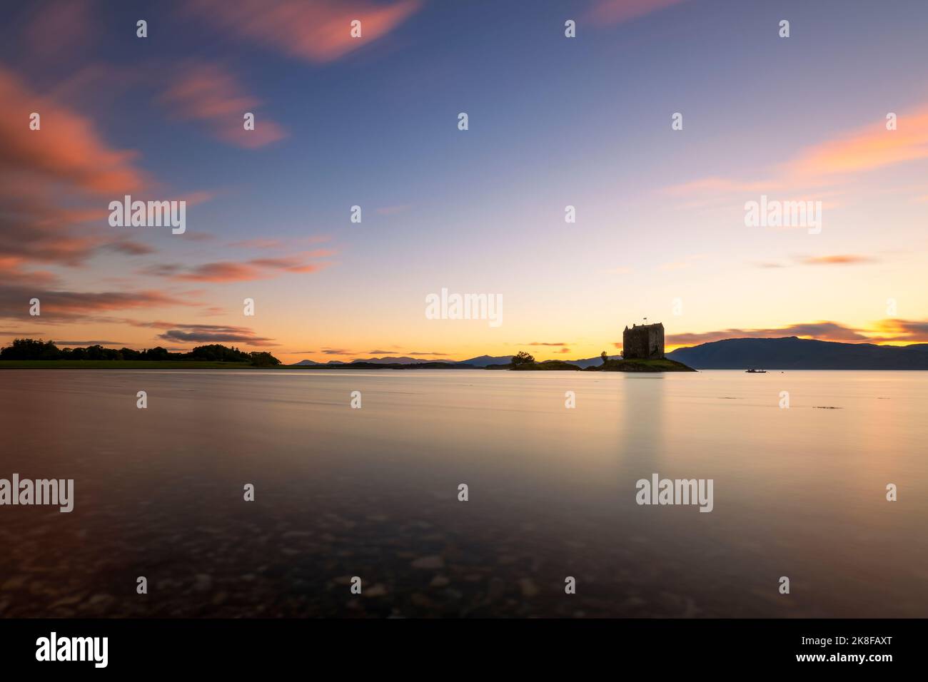 Scenic view of Castle Stalker on Loch Linnhe at sunset, Scotland Stock ...