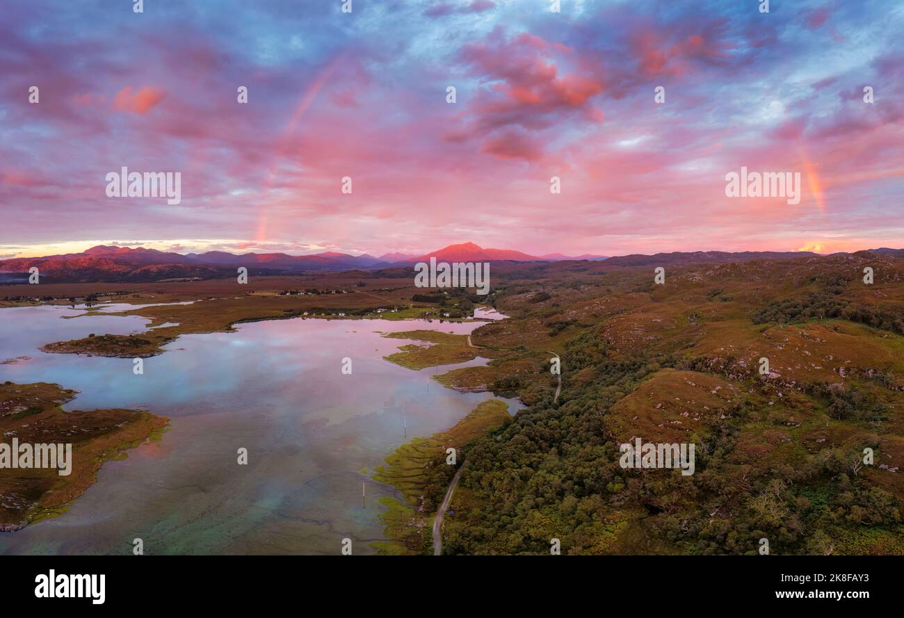 Scenic view of Kentra Bay with rainbow at sunset, Scotland Stock Photo ...