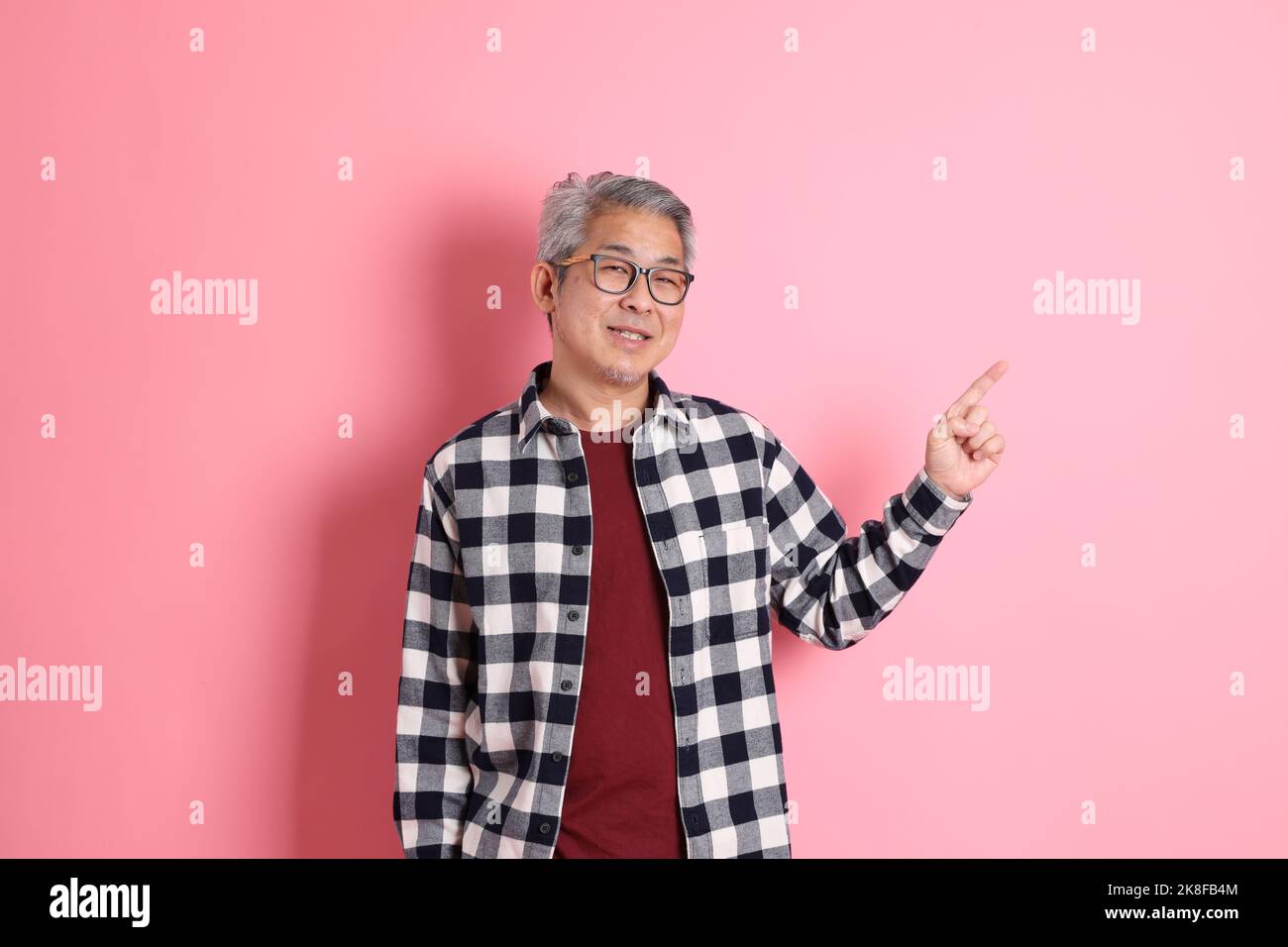 The 40s adult Asian man stnading on the pink background with casual ...