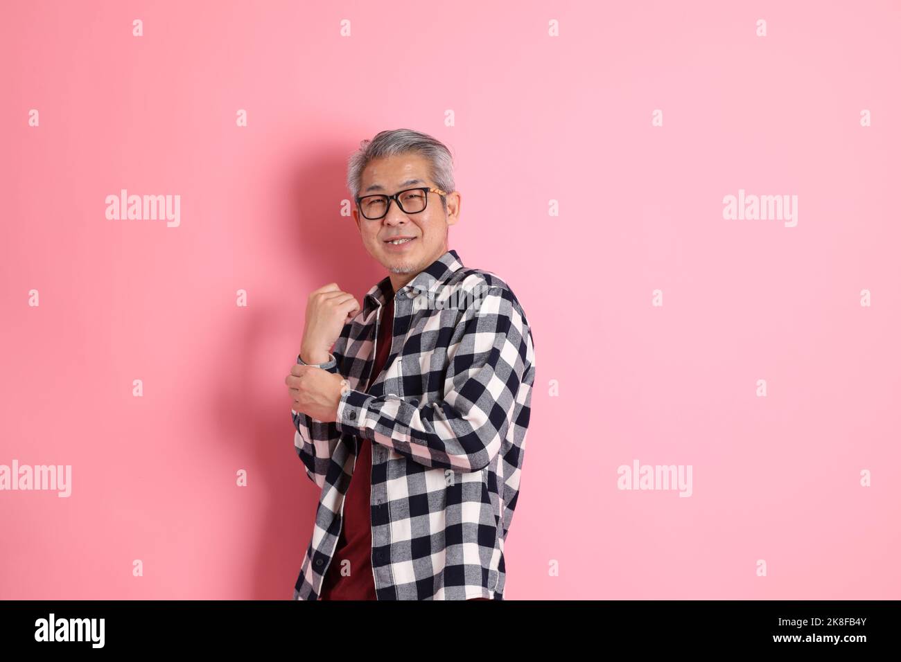 The 40s adult Asian man stnading on the pink background with casual ...