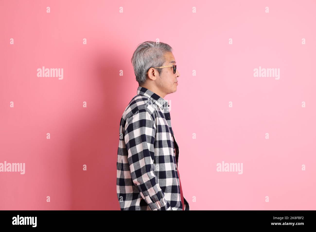 The 40s adult Asian man stnading on the pink background with casual ...