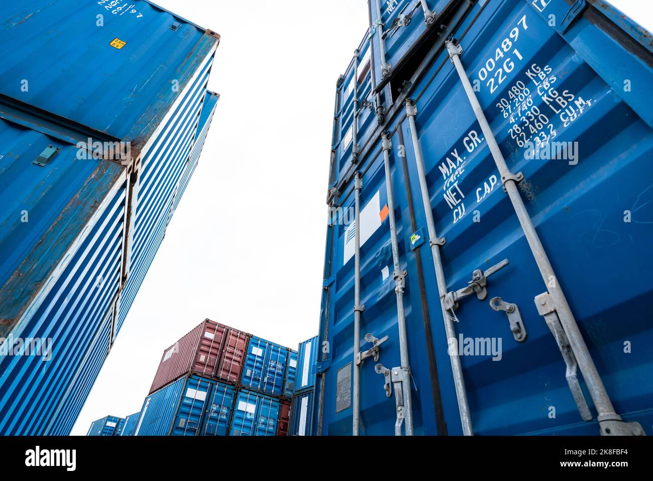 Blue and red logistic container against white sky. Cargo and shipping ...