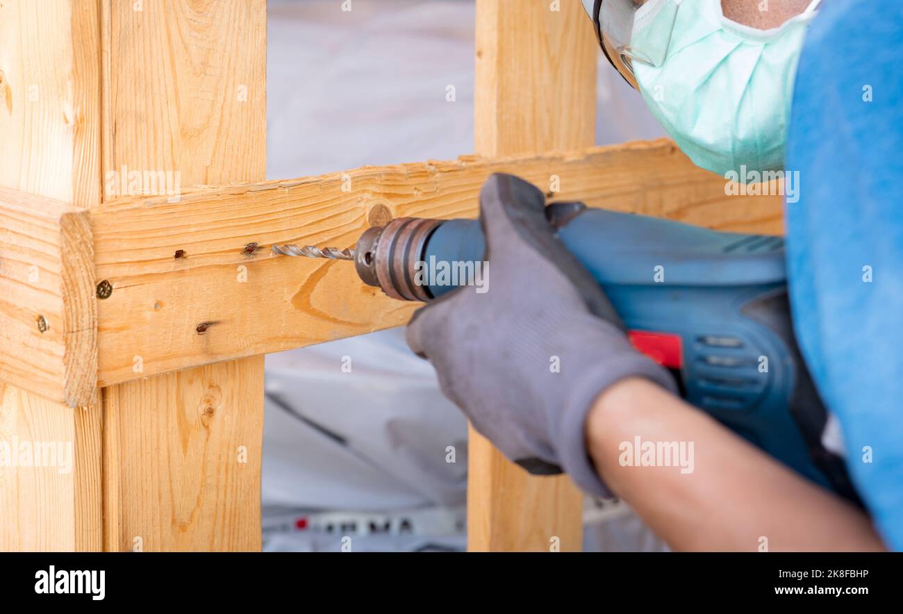 Technician drilling wooden box with drilling machine. Heavy machinery ...