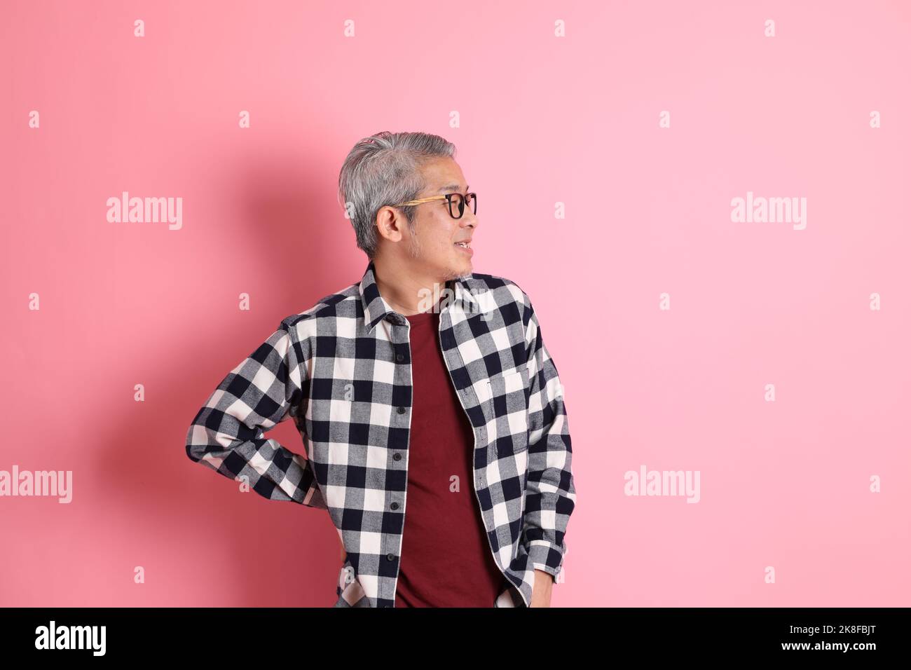 The 40s adult Asian man stnading on the pink background with casual ...