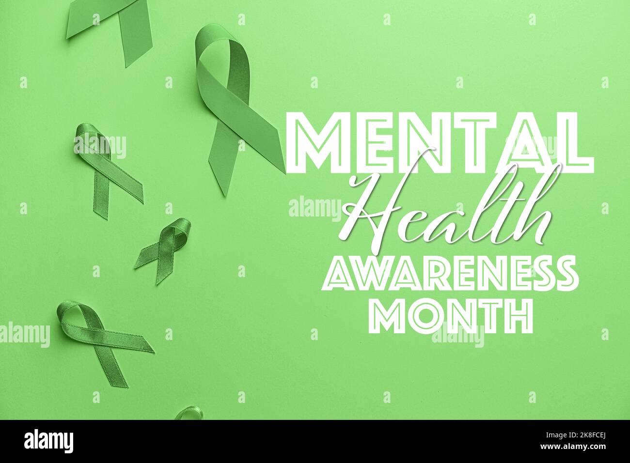 Green ribbons and text MENTAL HEALTH AWARENESS MONTH Stock Photo - Alamy