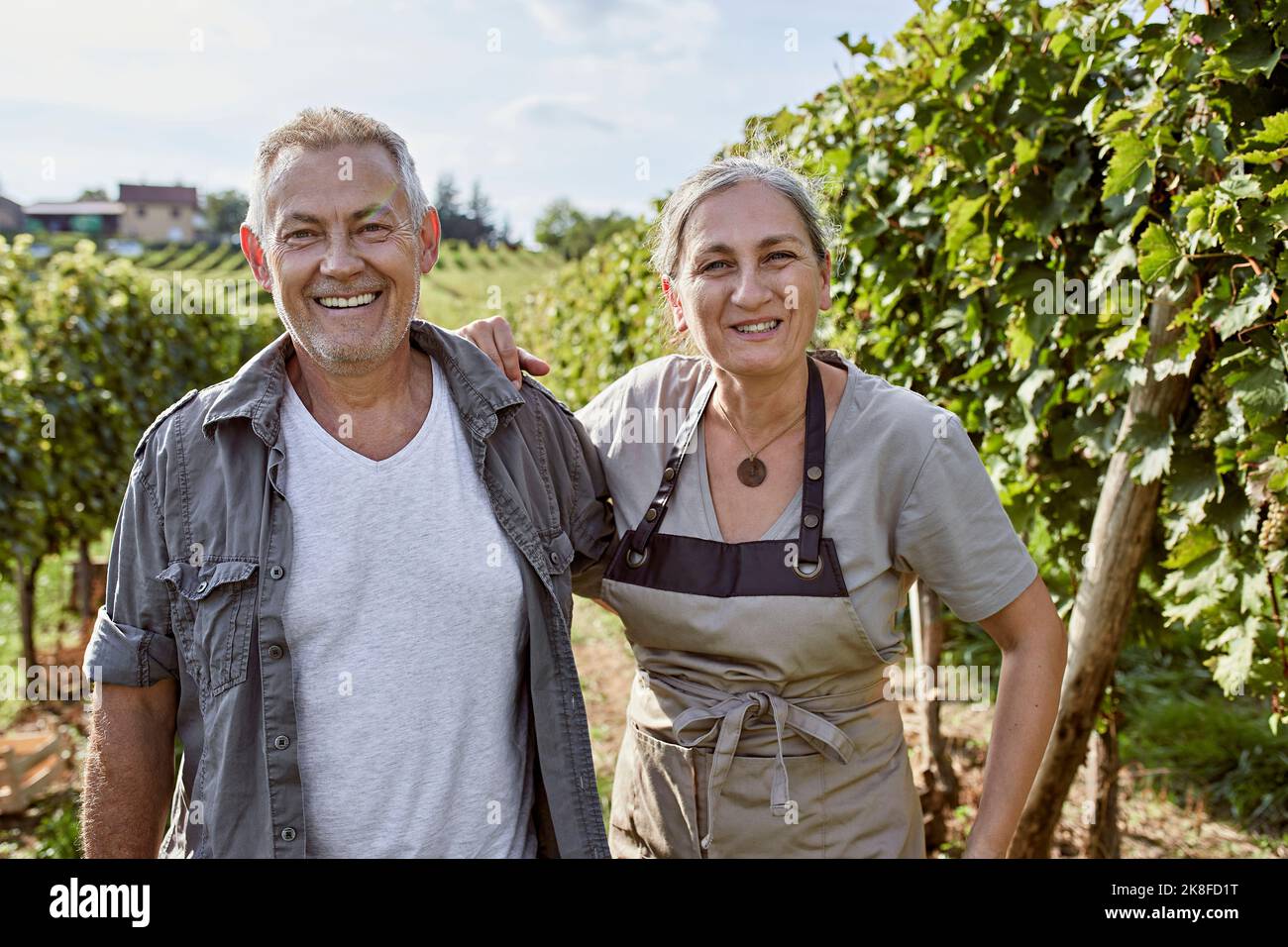 Happy mature farmers standing together at vineyard Stock Photo - Alamy
