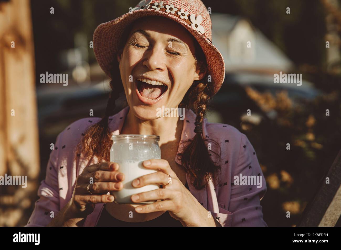Mature woman enjoying fresh milk on sunny day Stock Photo - Alamy