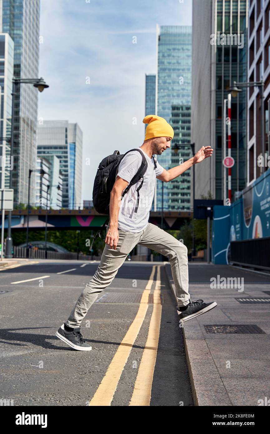 Man in hat walking on pavement hi-res stock photography and images - Alamy